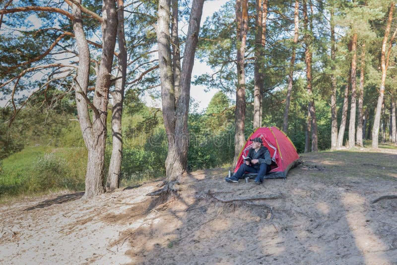 Man Resting on the Campsite Reading a Book Stock Photo - Image of sunny ...