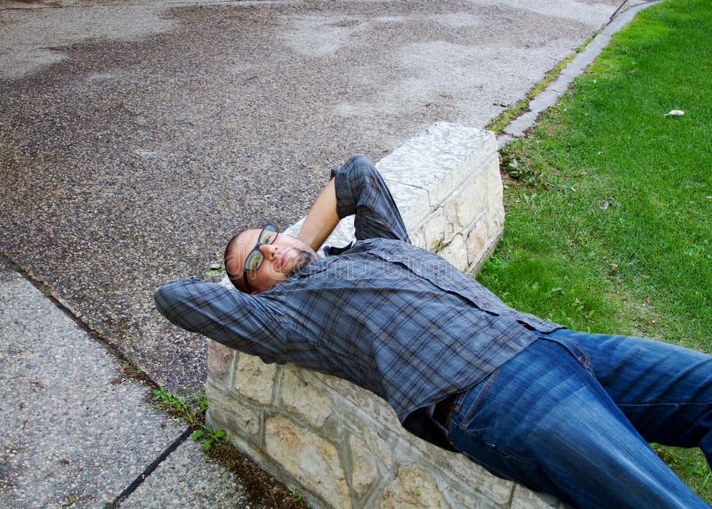 Man Resting on a Cement Bench Stock Image - Image of lawn, relax: 49147641
