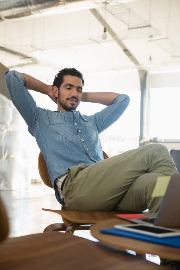 Man Resting on Chair in Office Stock Photo - Image of occupation ...