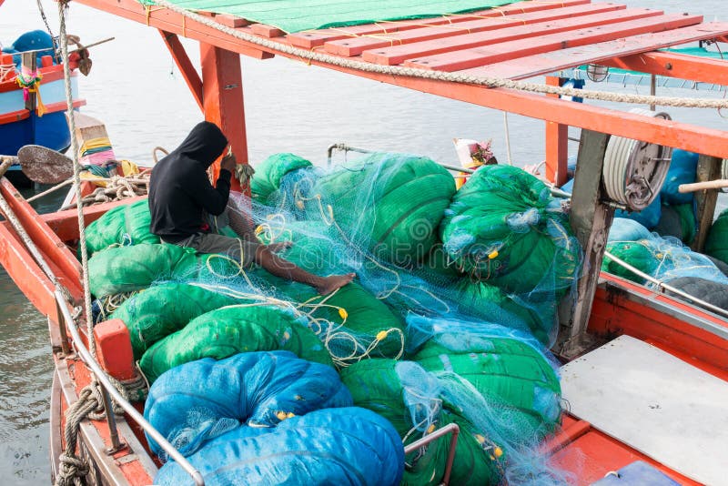 A Man Resting on Fishing Net Stock Photo - Image of maritime, fisherman ...
