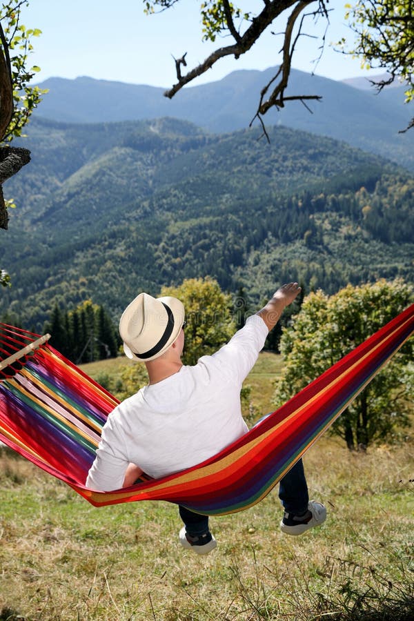 Man Resting in Hammock Outdoors on Sunny Day, Back View Stock Photo ...