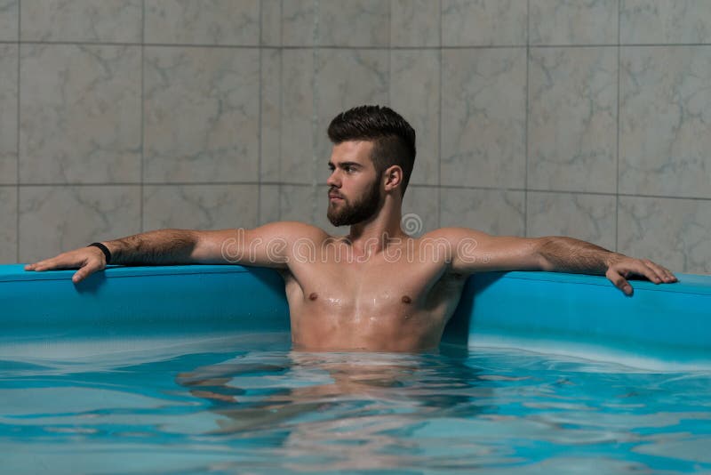 Man Resting Relaxed on Edge of Swimming Pool Stock Photo - Image of ...