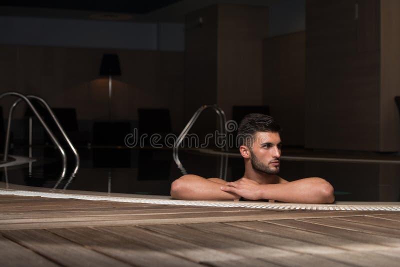 Man Resting Relaxed on Edge of Swimming Pool Stock Photo - Image of ...