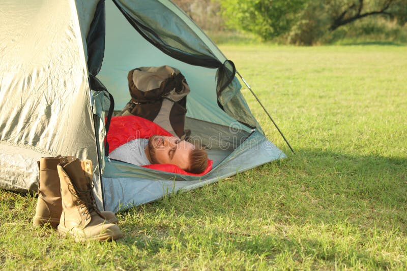 Man Resting in Sleeping Bag Inside Camping Tent Stock Image - Image of ...