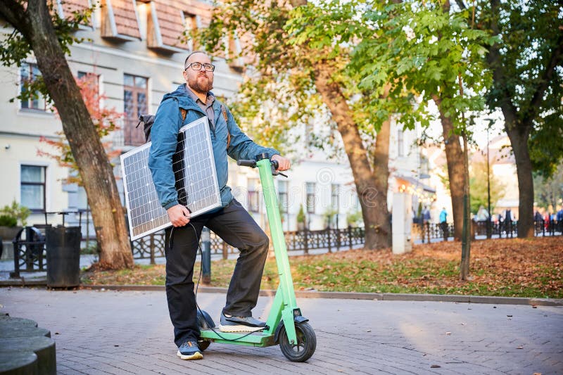 Man Rides Electric Scooter with Solar Panel. Integration of Solar Power ...
