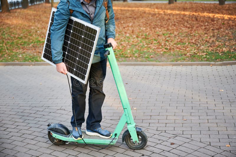 Man Rides Electric Scooter with Solar Panel. Integration of Solar Power ...