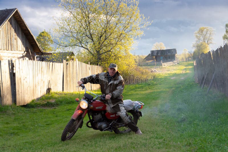 A Man Rides a Motorcycle on a Village Road. Editorial Image - Image of ...