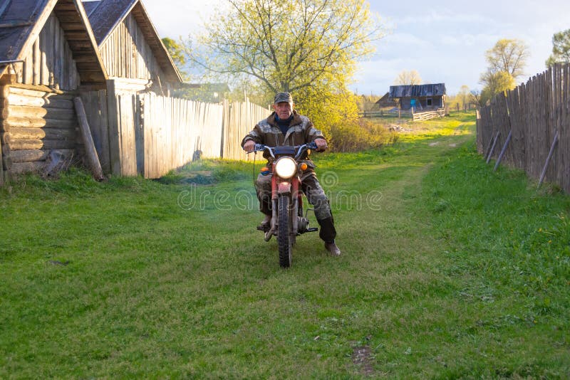 A Man Rides a Motorcycle on a Village Road. Editorial Photo - Image of ...