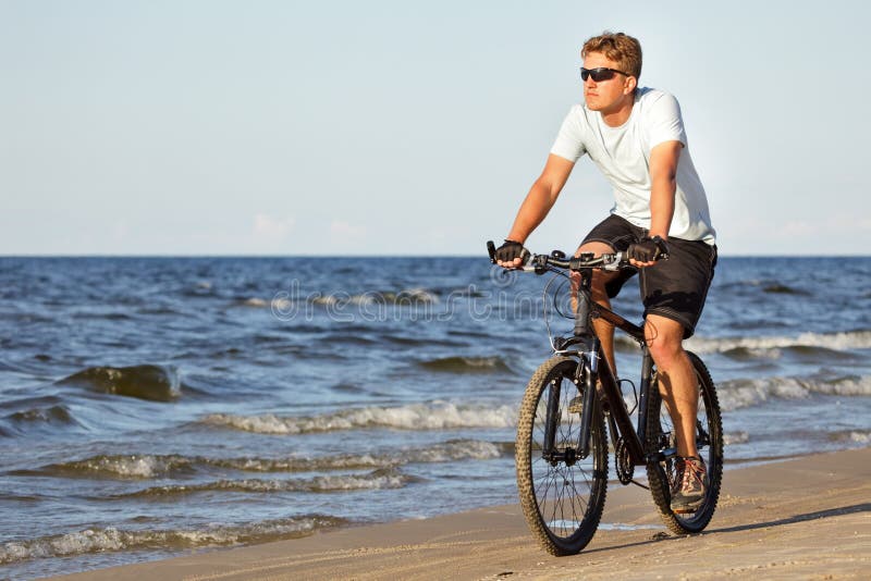 Man Riding Bicycle in Beach Stock Photo - Image of nature, adventure ...