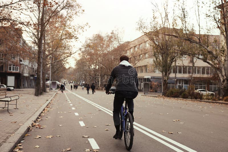 Man Riding Bicycle on Lane in City, Back View Stock Photo - Image of ...