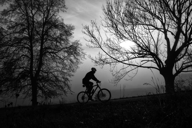 Man Riding a Bike Uphill through Foggy Autumn Morning Stock Image ... Man Riding a Bike Uphill through Foggy Autumn Morning Stock Image ...