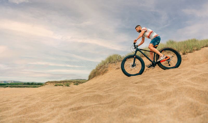 Man Riding a Fat Bike through the Beach Dunes Stock Photo - Image of ...