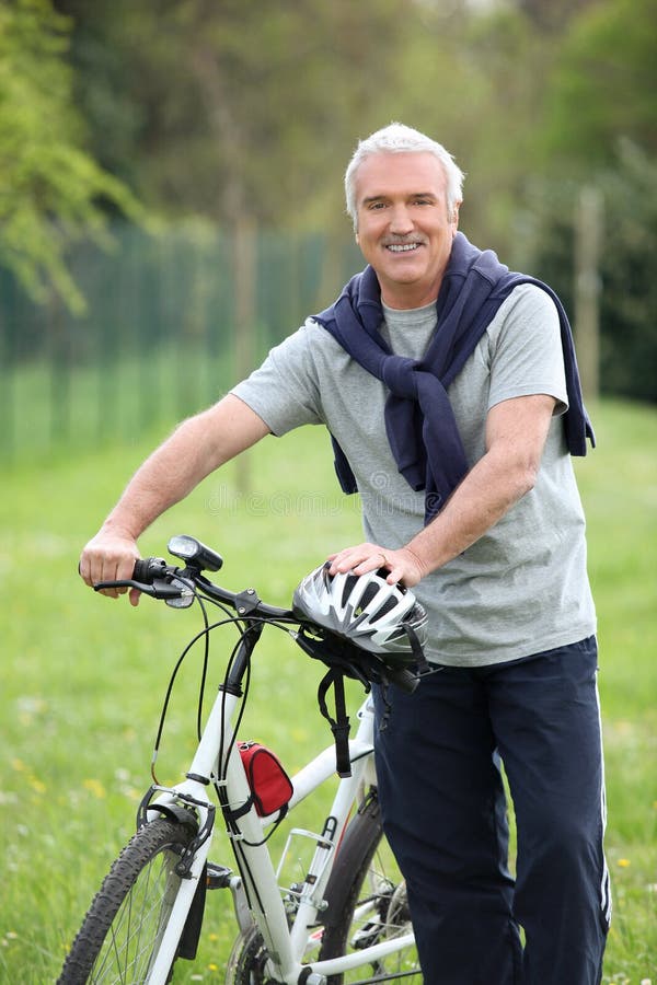 Old man riding bicycle stock image. Image of cheerful - 26463099