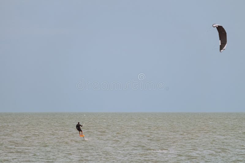 A Man is Riding a Hydrofoil Surf Board with Paraglide in Sea Stock ...