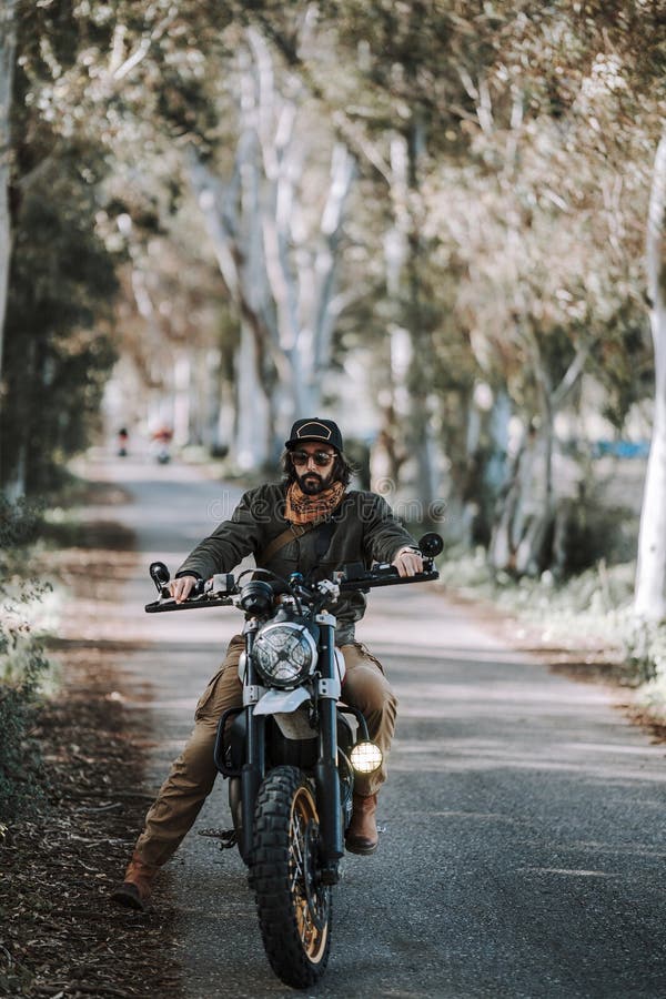 Man on Motor Cycle Going Down an Empty Tree Lined Path Stock Image ...