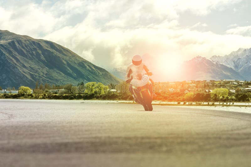 Man Riding Motorcycle on Highway Against Mountain Scene Stock Photo ...