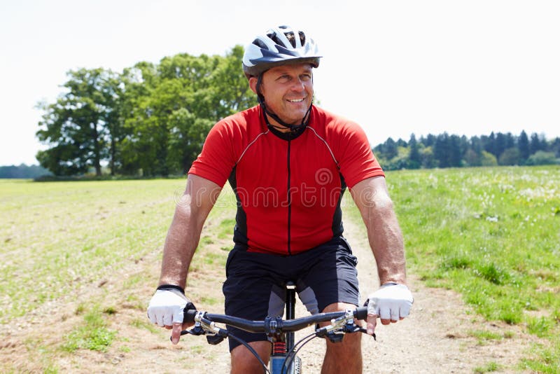 Man Riding Mountain Bike Along Path in Countryside Stock Photo - Image ...