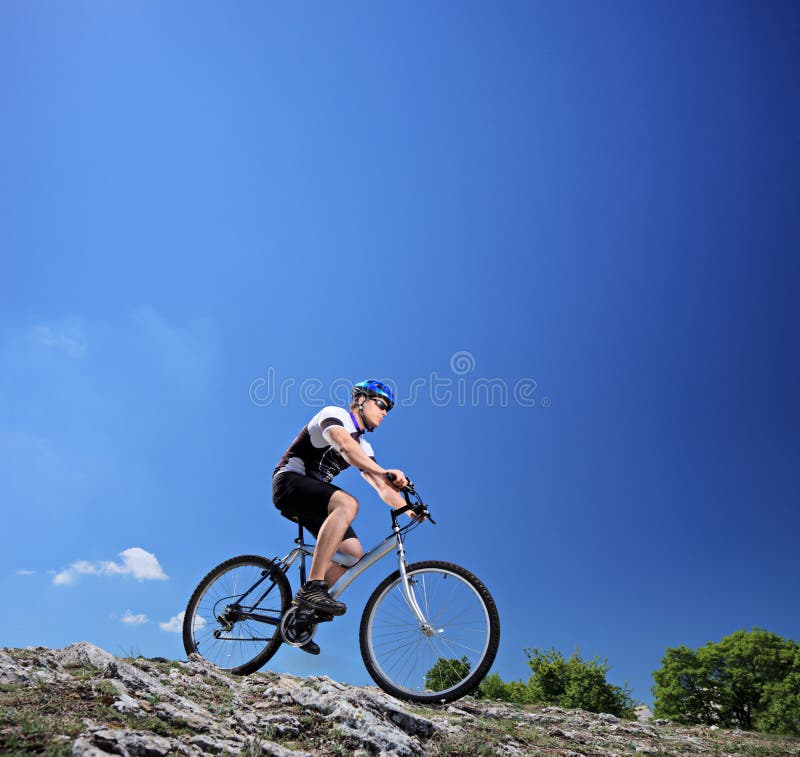 A Man Riding a Mountain Bike on a Slope Stock Photo - Image of motion ...