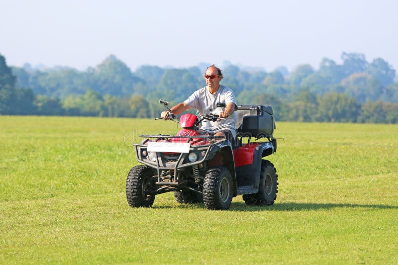 Man riding a quad bike stock image. Image of farm, machine - 383478411