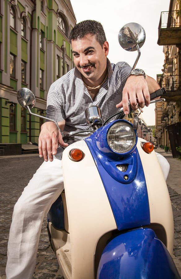 Man riding retro scooter stock image. Image of adult - 34256701