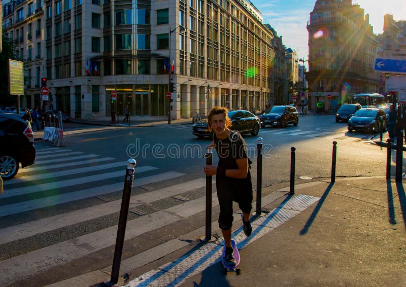 A Man Is Riding A Skateboard Down The Street Editorial Photography