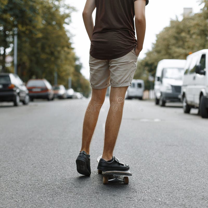 Man Riding on a Skateboard. Legs on a Skateboard. Stock Photo - Image ...