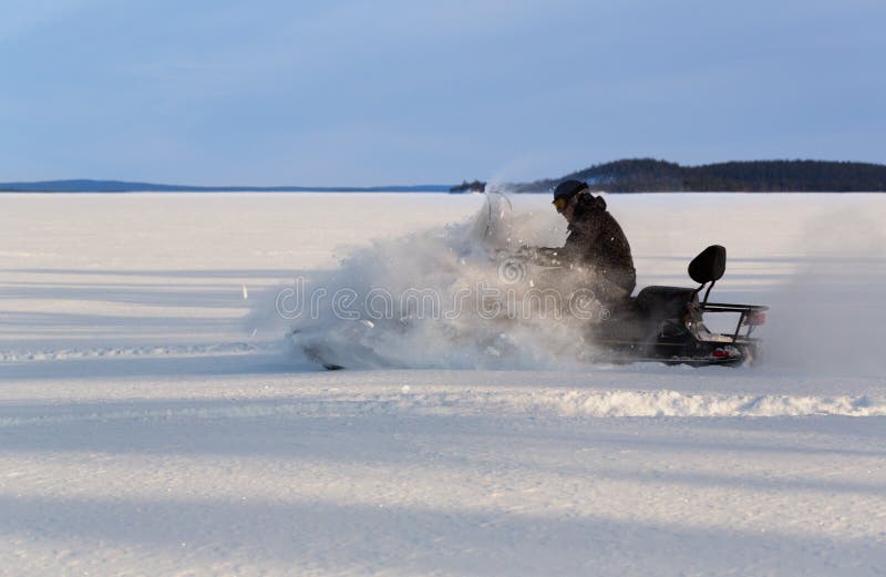 Man riding a snowmobile stock image. Image of recreational - 30653129
