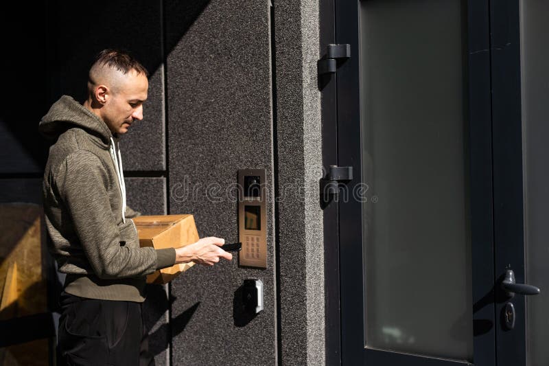 Man Ringing Intercom with Camera Near Building Entrance. Stock Image ...