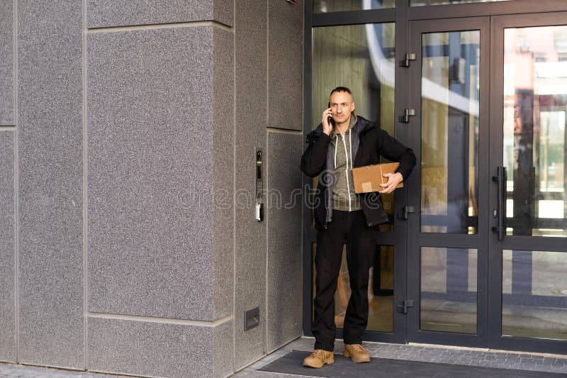 Man Ringing Intercom with Camera Near Building Entrance. Stock Image ...
