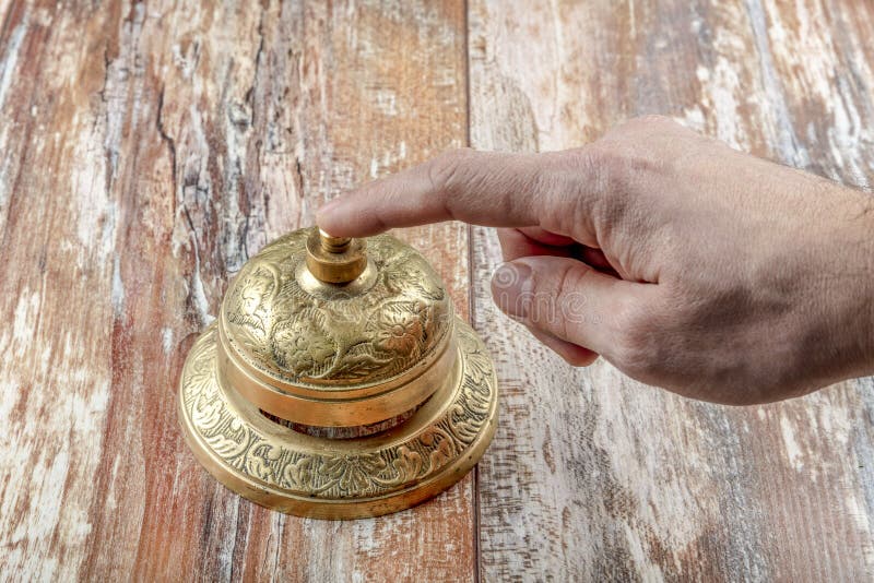 Man Ringing in Service Bell on Reception Table, Closeup Stock Image ...