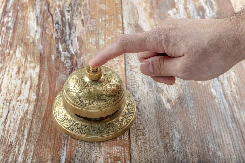 Man Ringing in Service Bell on Reception Table, Closeup Stock Image ...