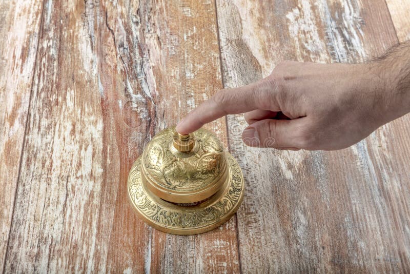 Man Ringing in Service Bell on Reception Table, Closeup Stock Photo ...