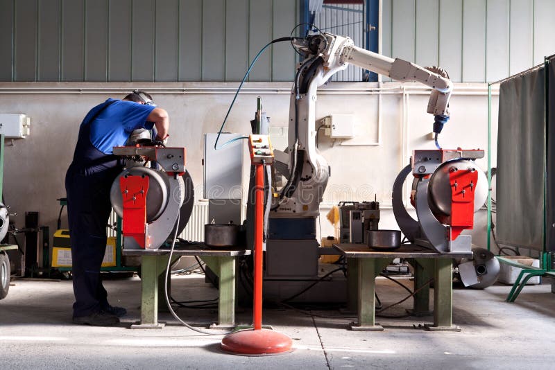 Man and Robotic Machine Work Together Inside Industrial Building Stock ...