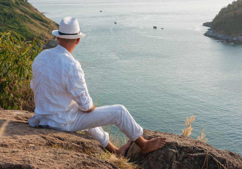 Man Sitting on a Rock and Looking at the Sunset of Phuket Stock Photo ...