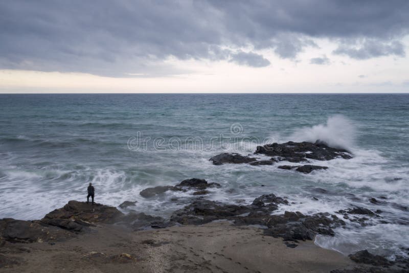 Man on a Rock in the Water with Strong Waves Stock Image - Image of ...
