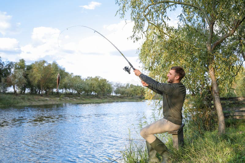 Man with Rod Fishing at Riverside Stock Image - Image of lake, catch ...