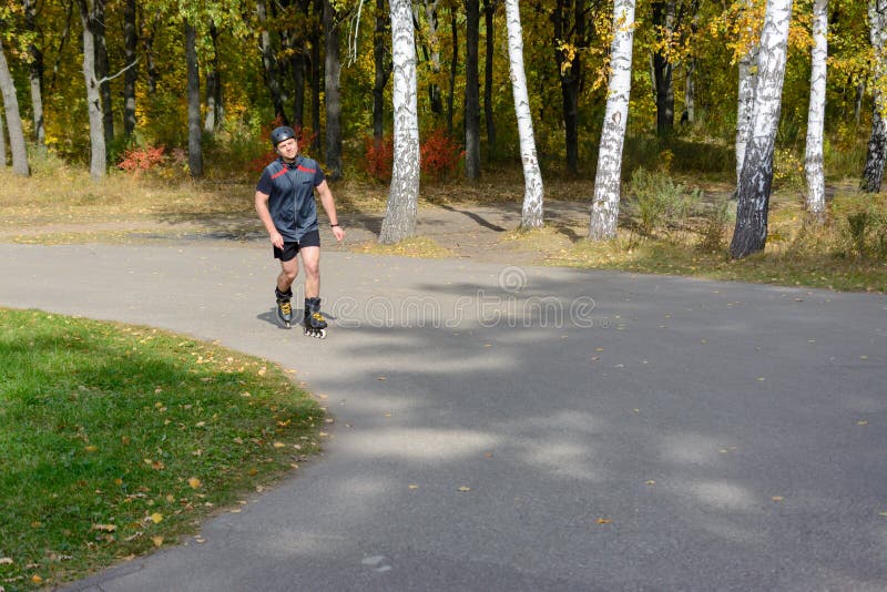 A Man is Rollerblading in the Park Stock Photo - Image of motion, park ...