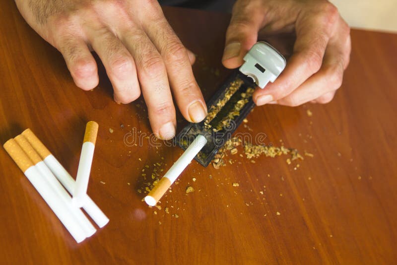 Man Rolling Cigarettes Using Fresh Tobacco Stock Image - Image of ...
