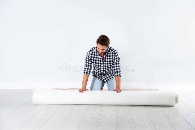 Man Rolling Out New Carpet Flooring Stock Photo - Image of carpeting ...