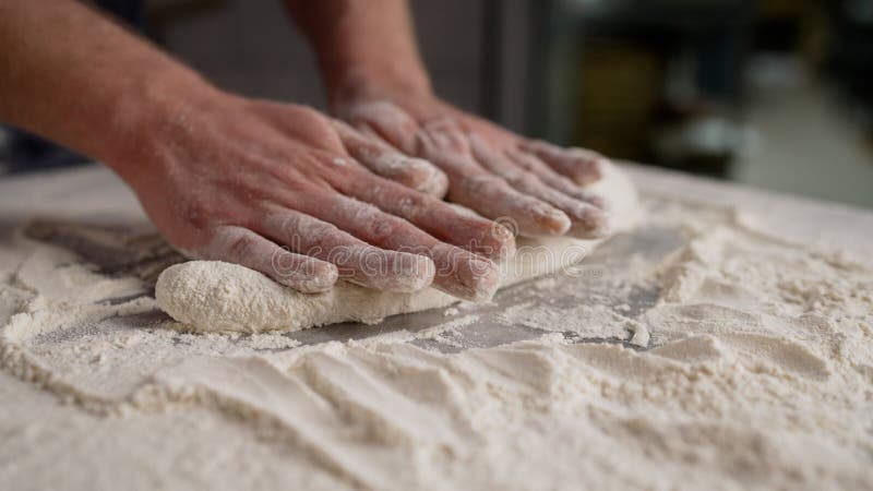 Rolling Out Dough Close-up. a Man Rolls the Dough on a Wooden Table ...