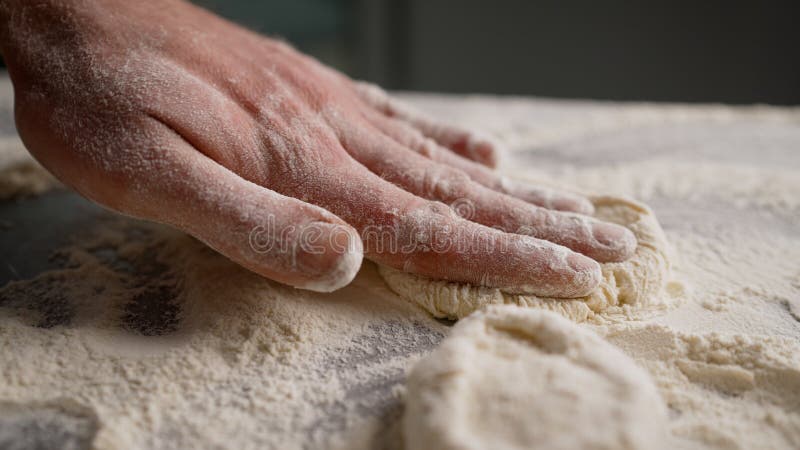 Rolling Out Dough Close-up. a Man Rolls the Dough on a Wooden Table ...