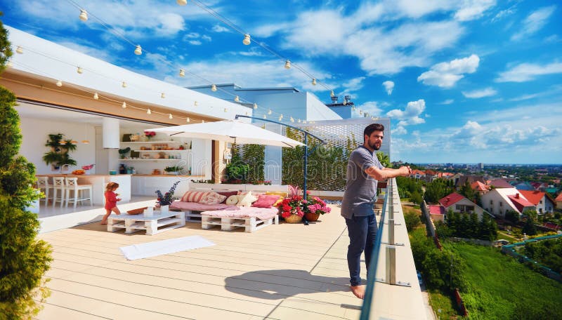 Man on the Rooftop Summer Patio with Open Space Kitchen, Enjoying the ...