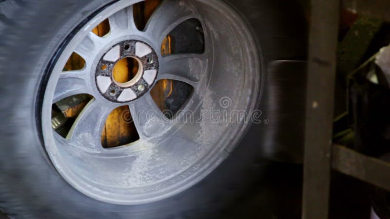 Man Rotates Car Wheel and Shrink Tyre by Special Stock Video - Video of ...