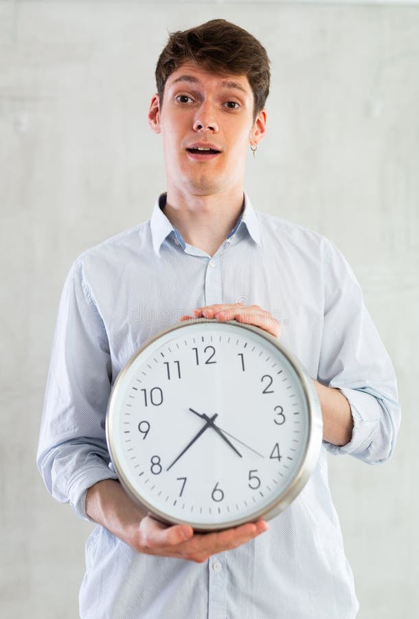 Man with a Round Big Clock in His Hands Expresses Various Emotions ...