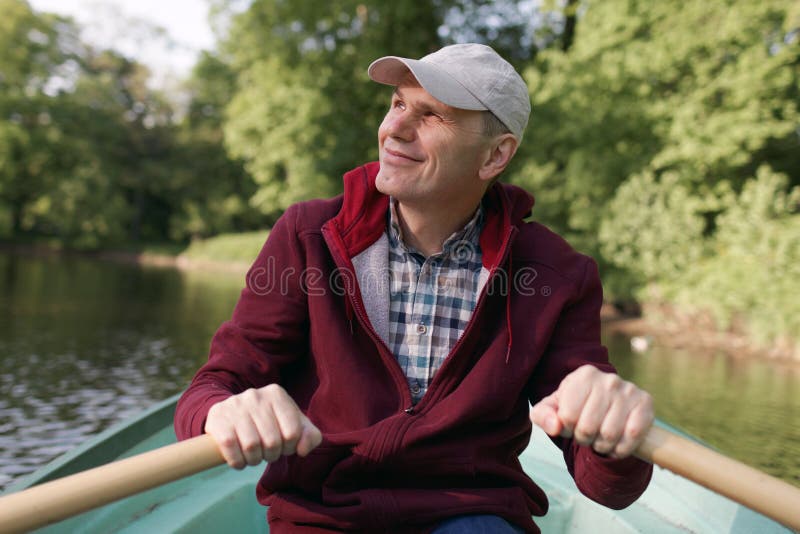 Man on a rowboat stock image. Image of caucasian, lake - 208067533