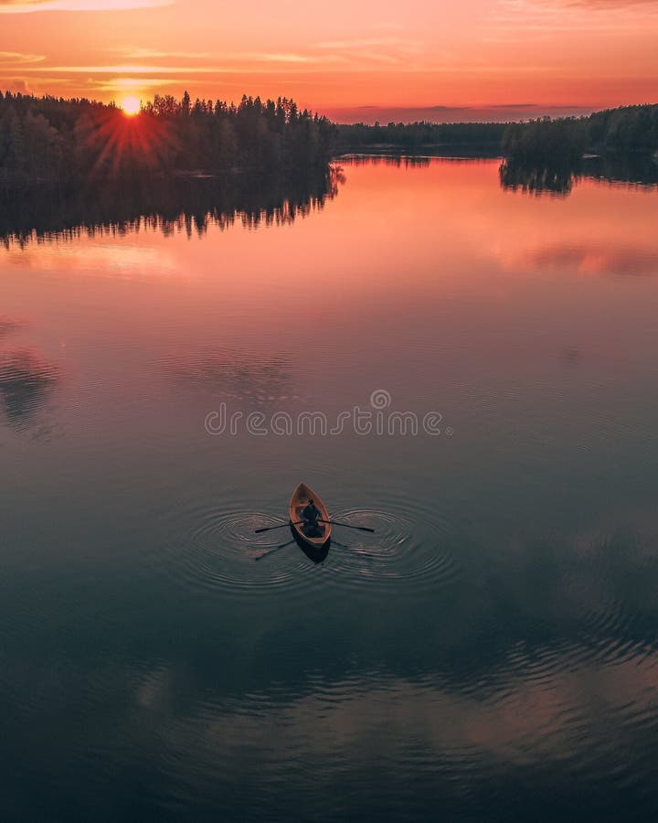 A Man Rowing on a Calm Lake at Sunset Stock Image - Image of amazing ...