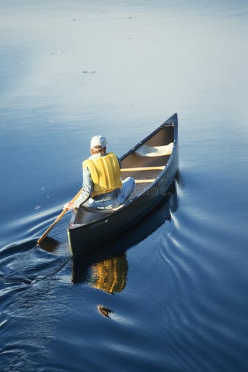 Man rowing a canoe editorial stock photo. Image of leaves - 23148458