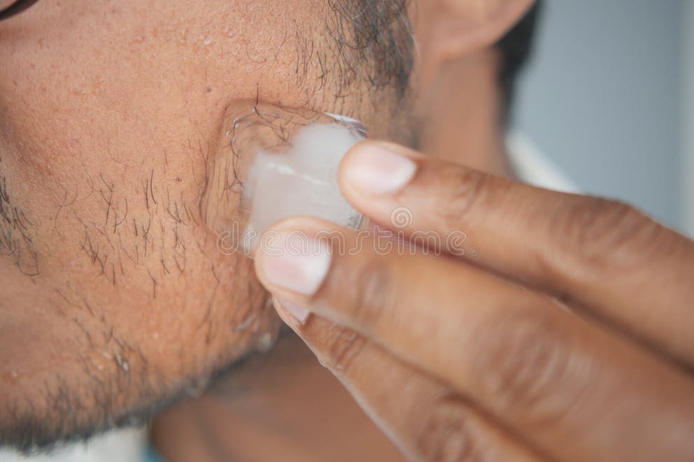 Man Rubbing Ice Cube on His Face. Stock Photo - Image of rubbing ...