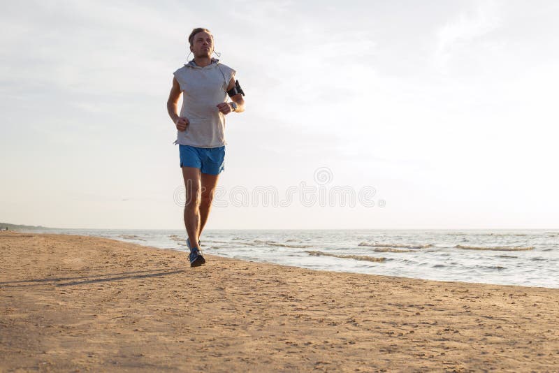 Man Running Along the Coast Line Stock Image - Image of water, beach ...