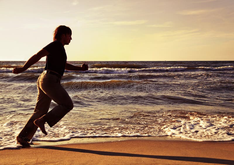 Man running along seashore stock image. Image of dawn - 24224353